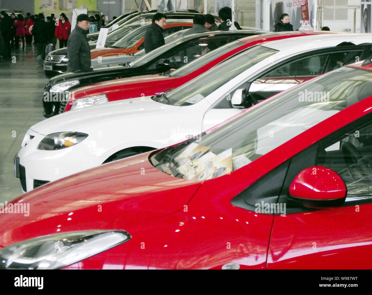 --FILE--Chinese visitors look at cars during an auto show in Nanjing ...