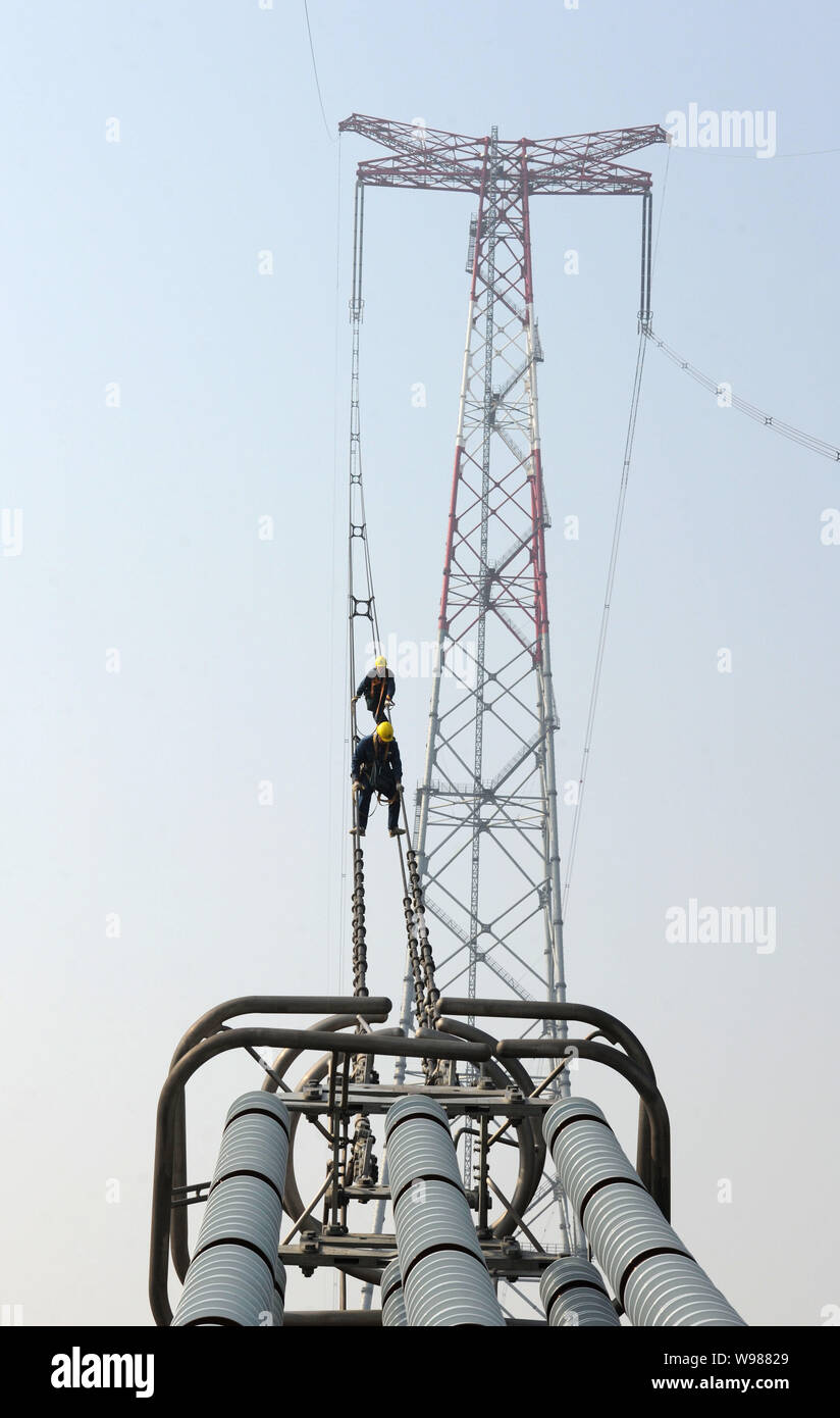 Chinese electricians check and repair UHV (ultra high voltage) electric ...