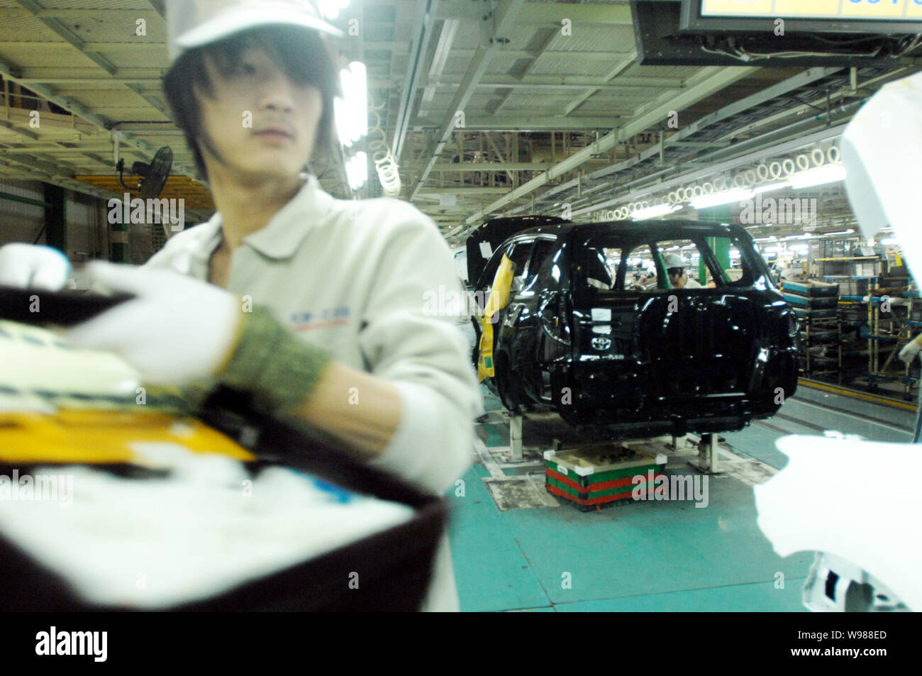 Chinese factory workers assemble Toyota cars on the assembly line at an ...