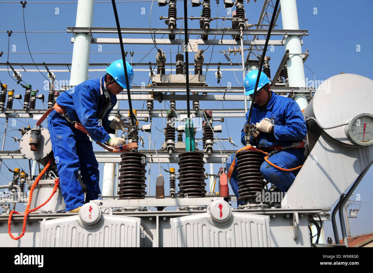 --FILE--Chinese electricians check and repair electrical device at a ...