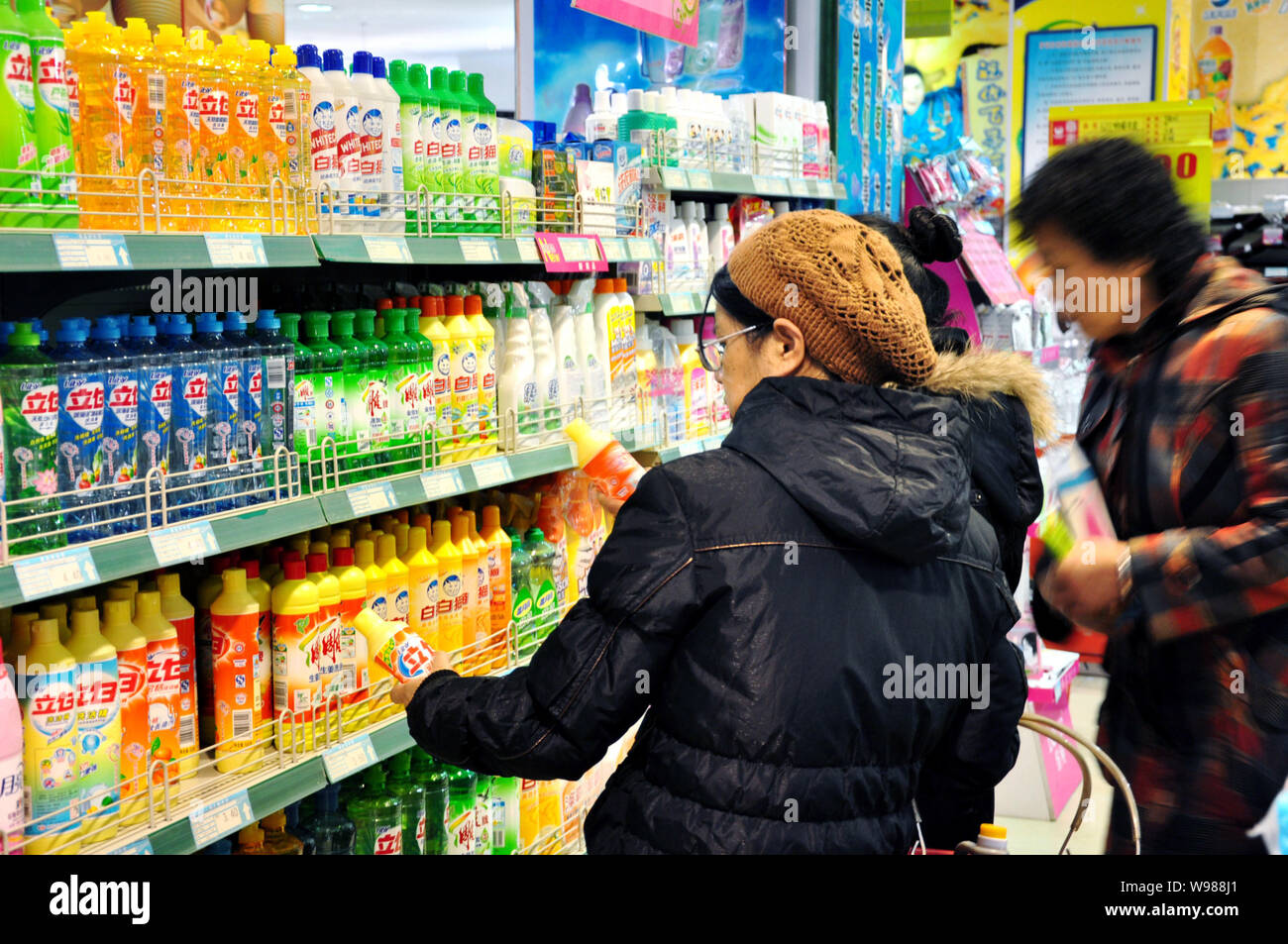 Chinese shoppers buy dishwashing liquid at a supermarket in Yakeshi ...