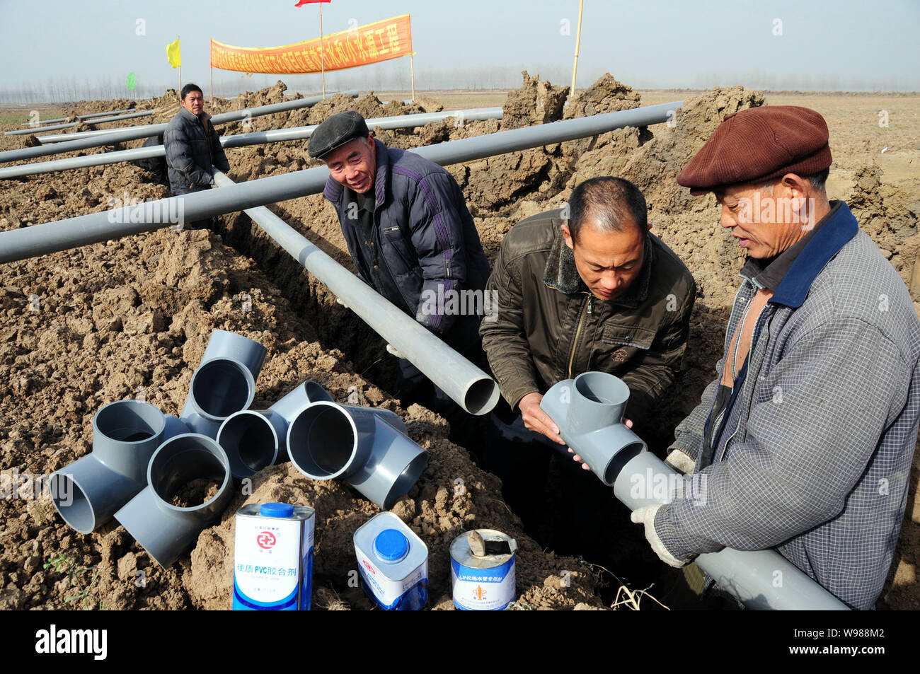 --FILE--Chinese workers connect water pipes during the construction of ...