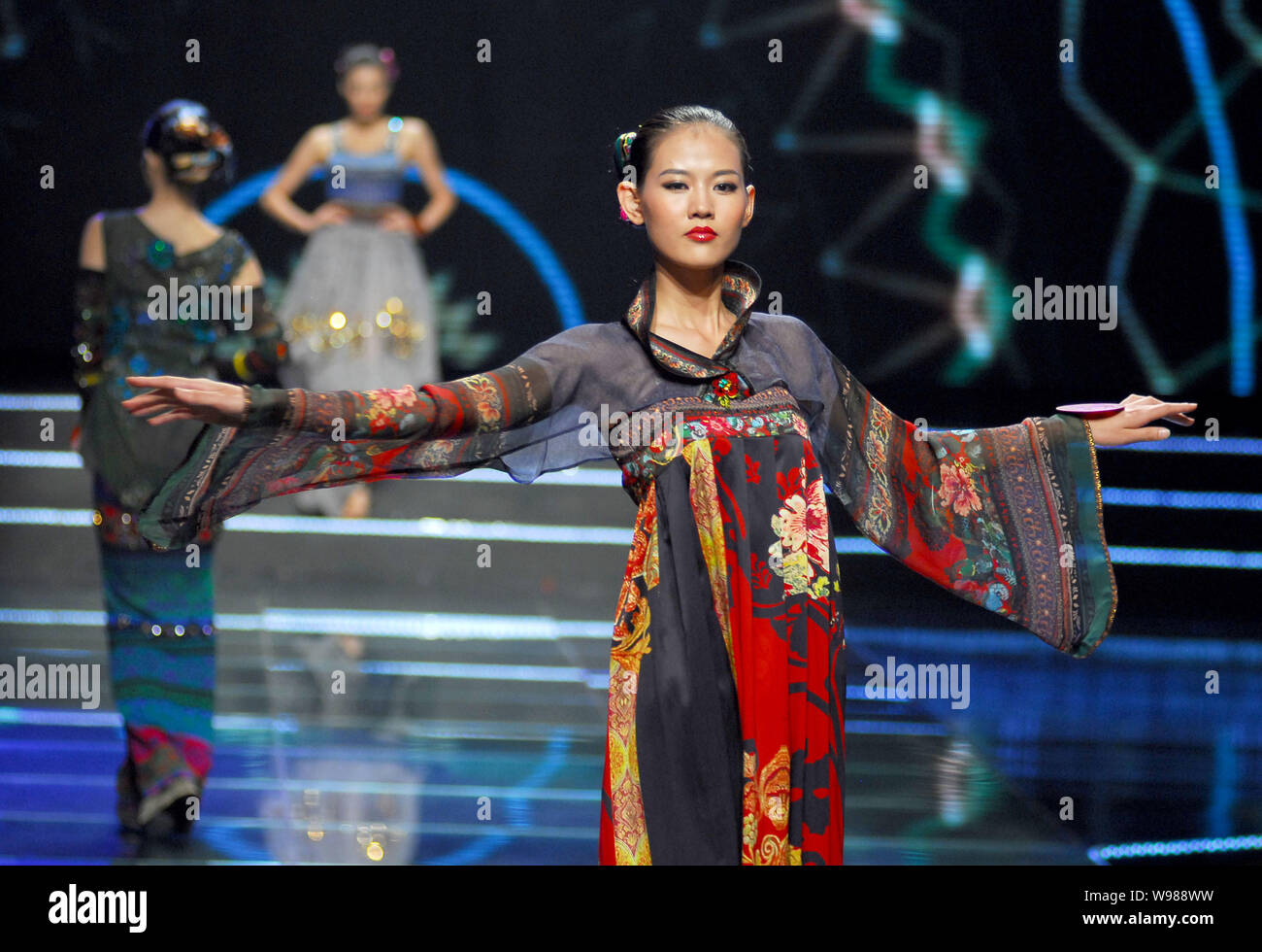 Models wearing garments with Chinese elements pose on the stage during ...