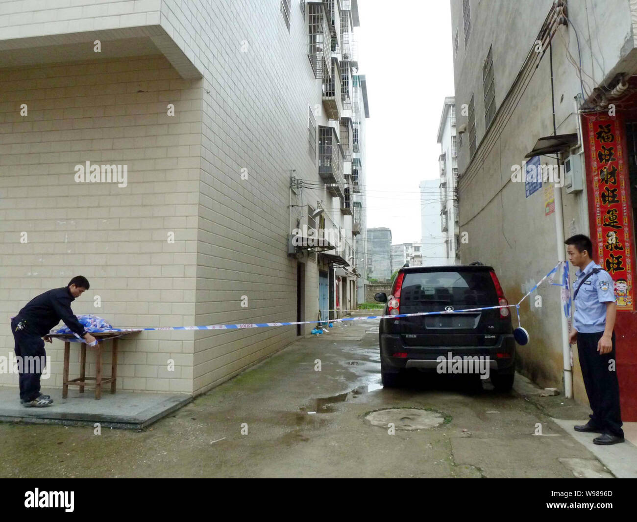 Police officers cordon off the area near the home of Zhou Zixiong, head ...