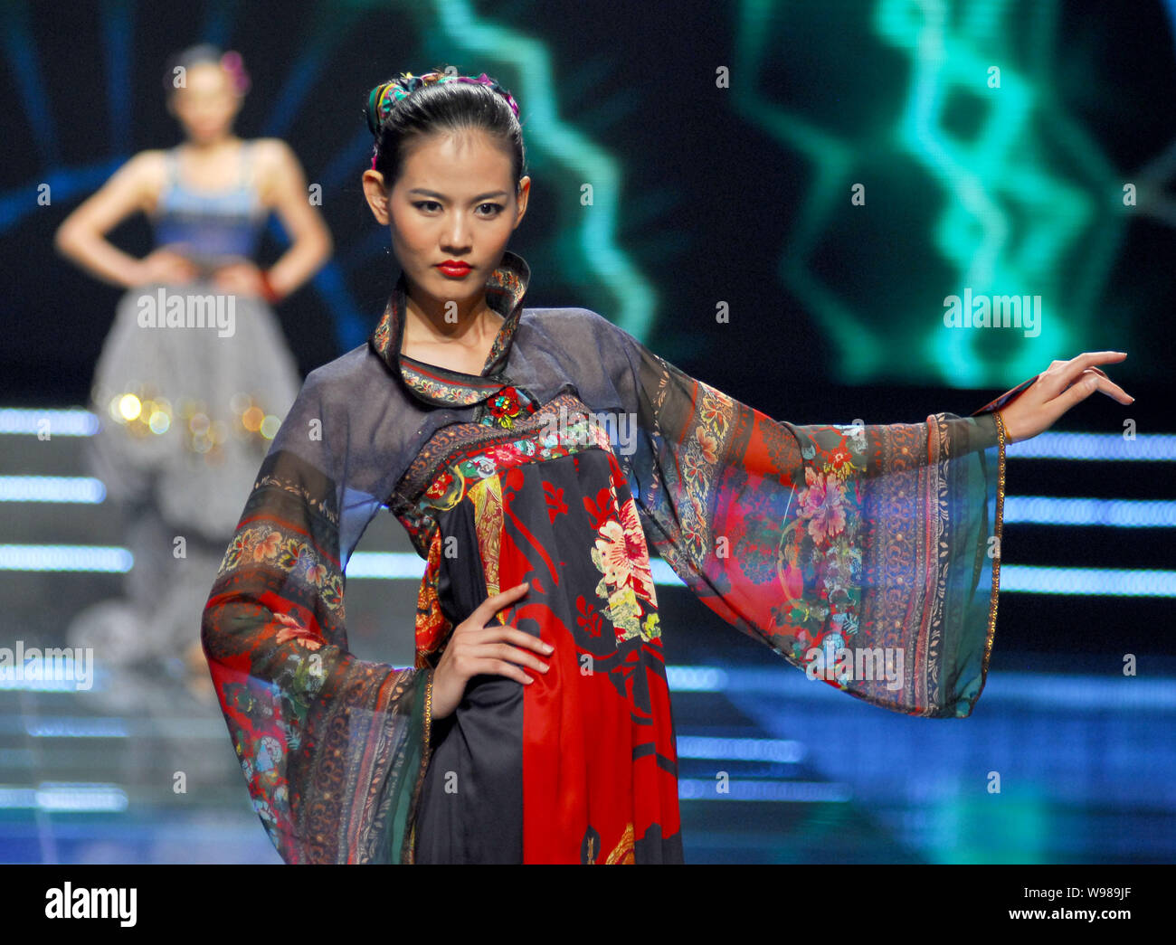 Models wearing garments with Chinese elements pose on the stage during ...