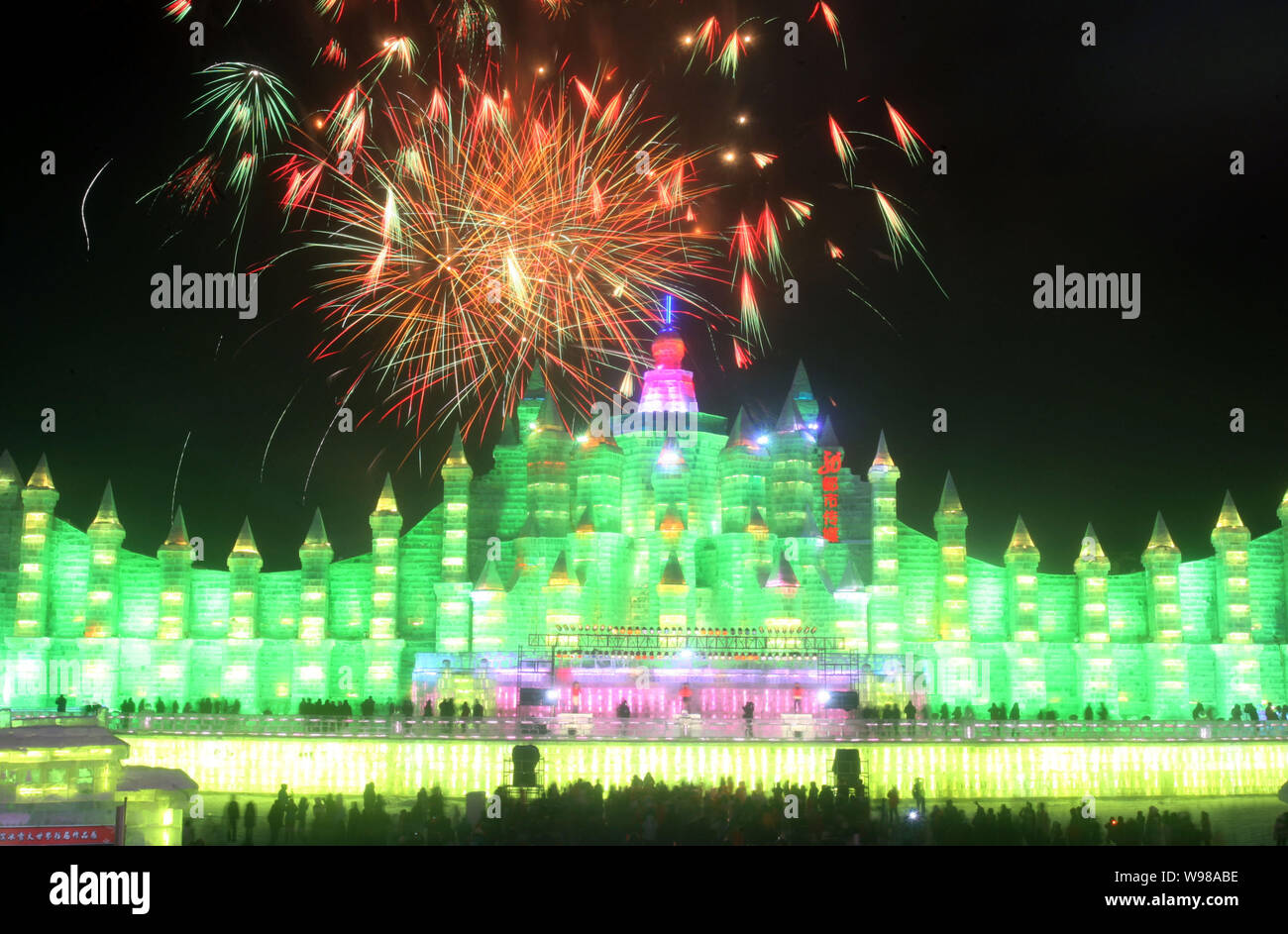 Fireworks explode over illuminated ice-made structures during the 27th ...