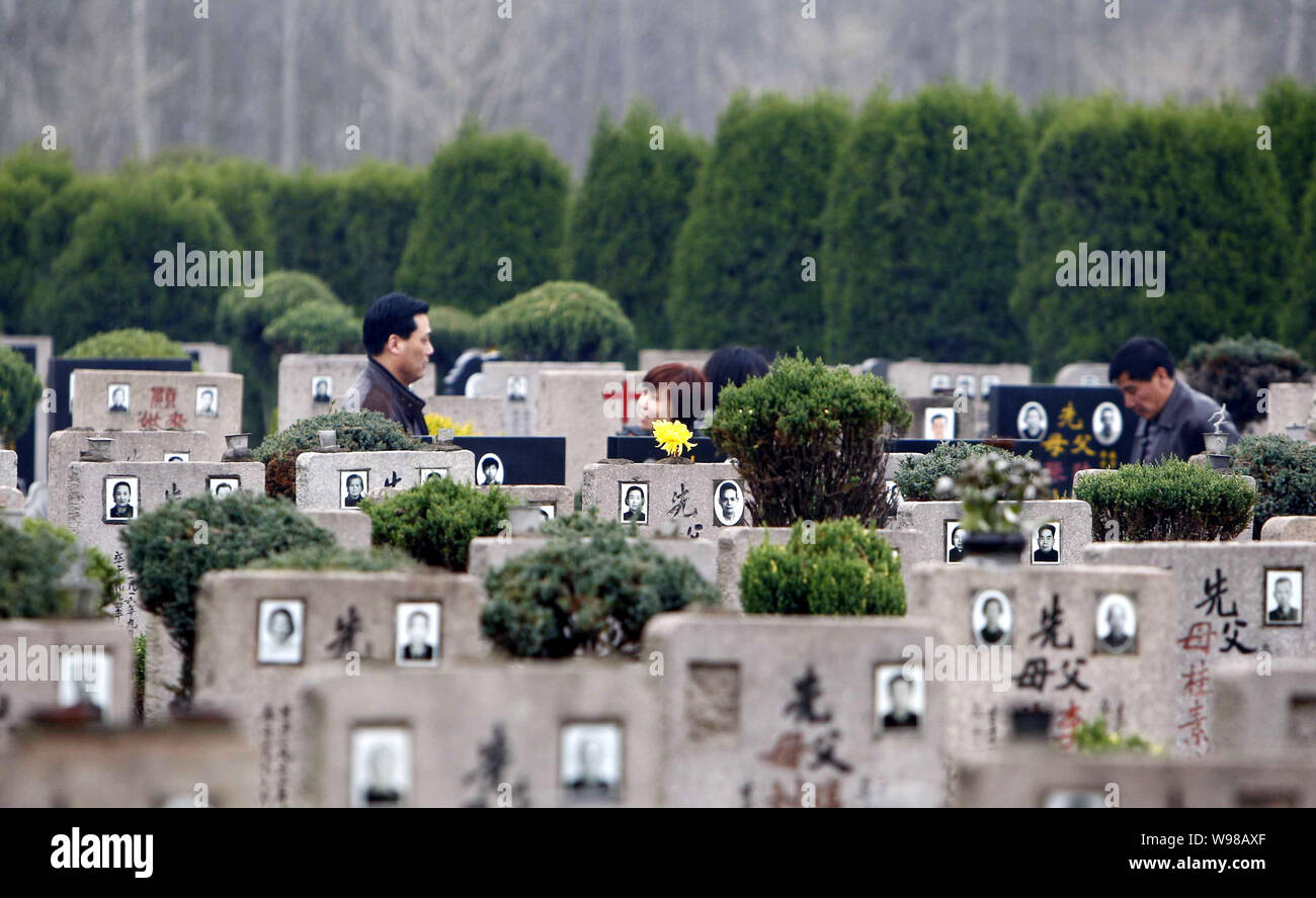Local Chinese residents mourn their deceased family members at a ...