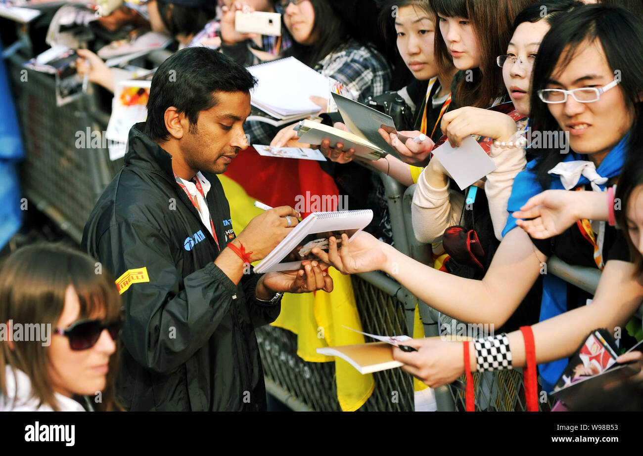 Indian F1 driver Narain Karthikeyan of the Hispania Racing team signs ...