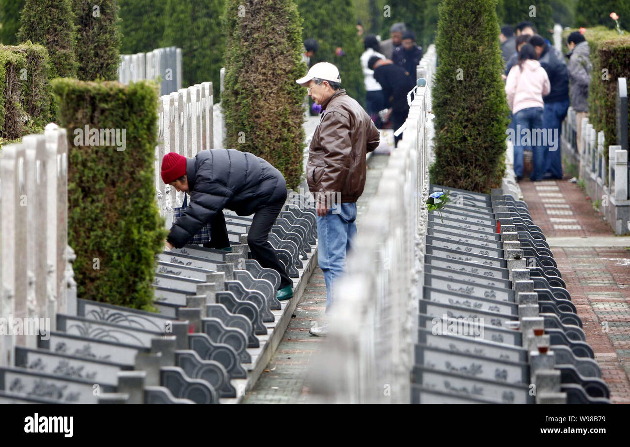 Local Chinese residents mourn their deceased family members at a ...