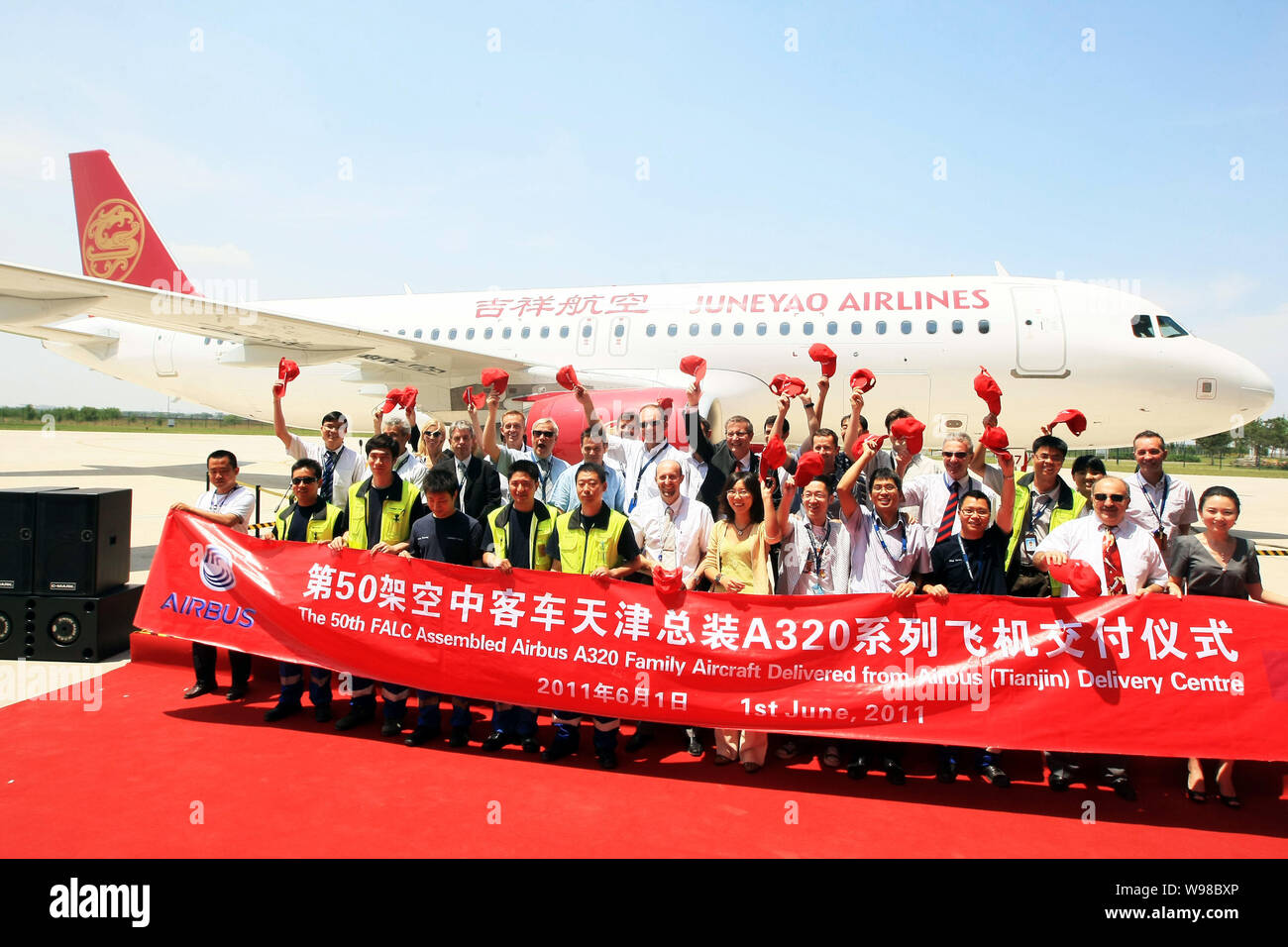Guests celebrate during a delivery ceremony for the 50th Airbus A320 ...