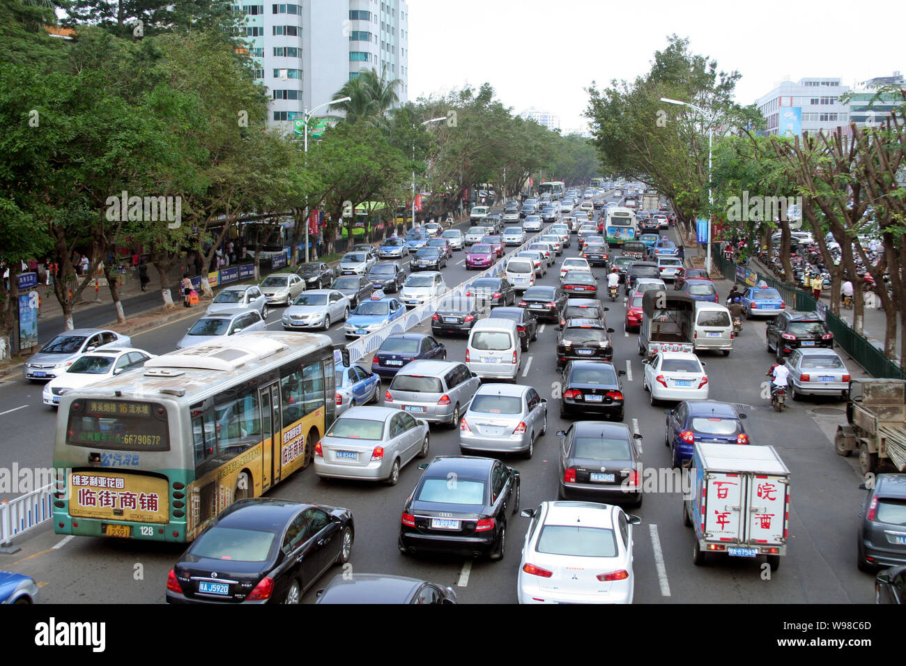 --File-- Masses of cars and buses are seen on a road in Haikou city ...