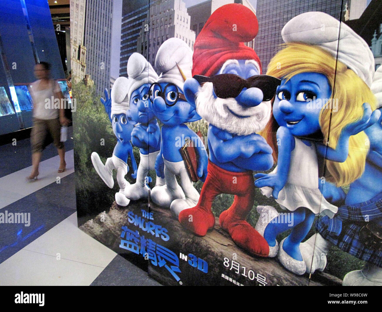 --File--A woman walks past a Smurfs poster in Taizhou, east Chinas ...