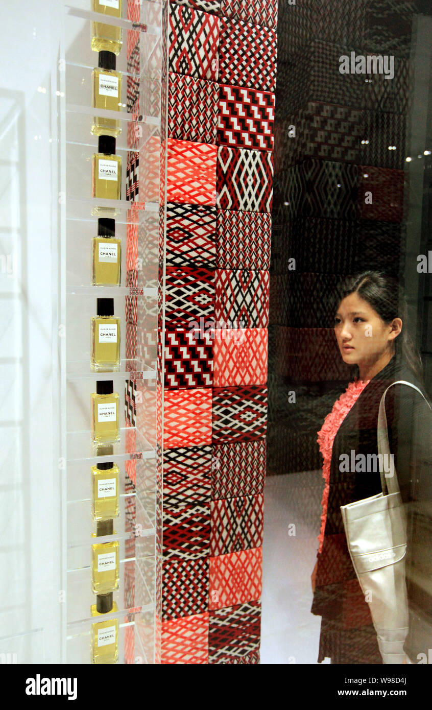 A visitor looks at Chanel perfume on display during the Culture Chanel ...