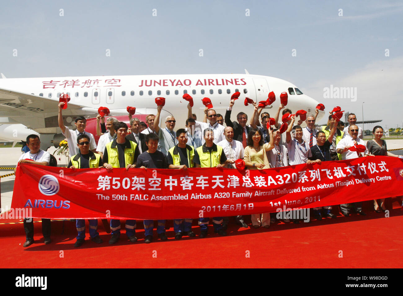 Guests celebrate during a delivery ceremony for the 50th Airbus A320 ...