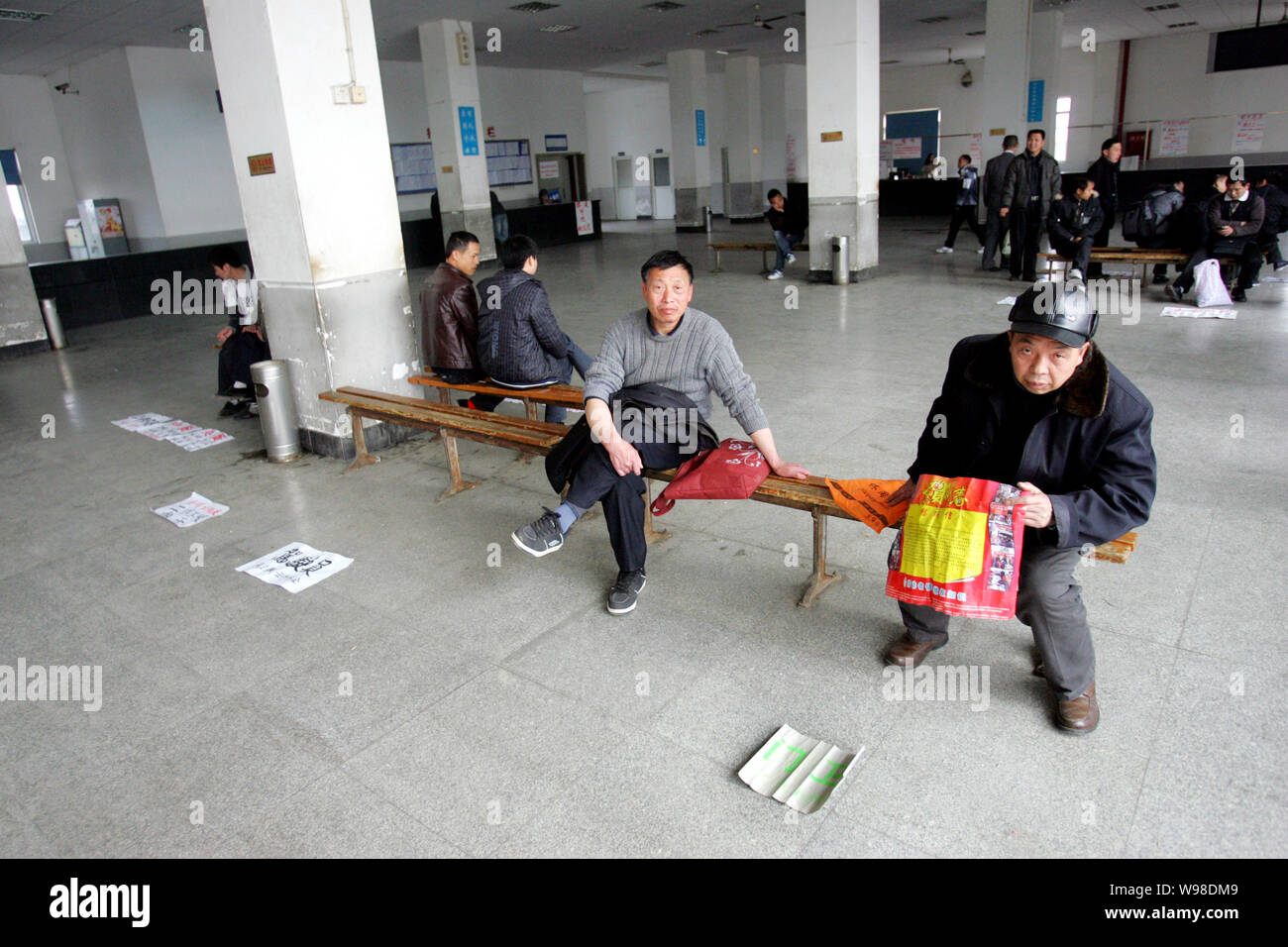 Chinese job seekers wait for employers behind placards showing their ...