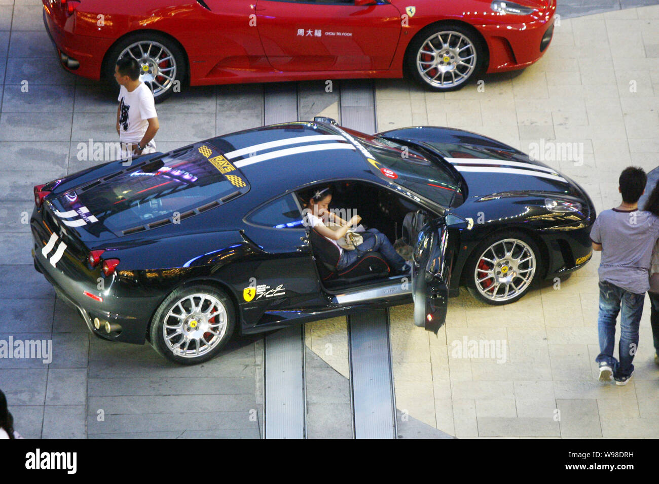 Chinese Ferrari owners drive their Ferrari sports cars at a shopping ...