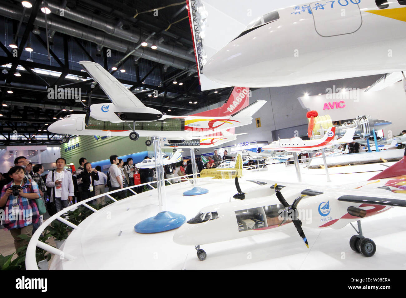 Visitors look at model planes at the stand of AVIC (Aviation Industry ...