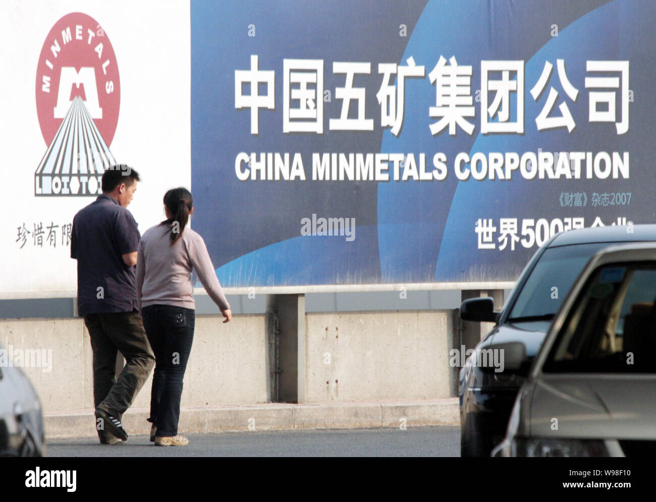 --FILE--Local Chinese residents walk past a billboard of China ...