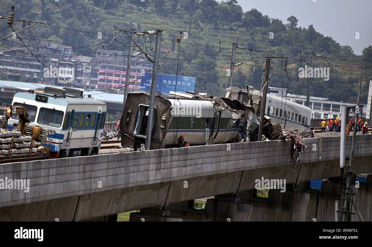 Rescuers try to remove the wreckage of the coaches of a CRH (China ...