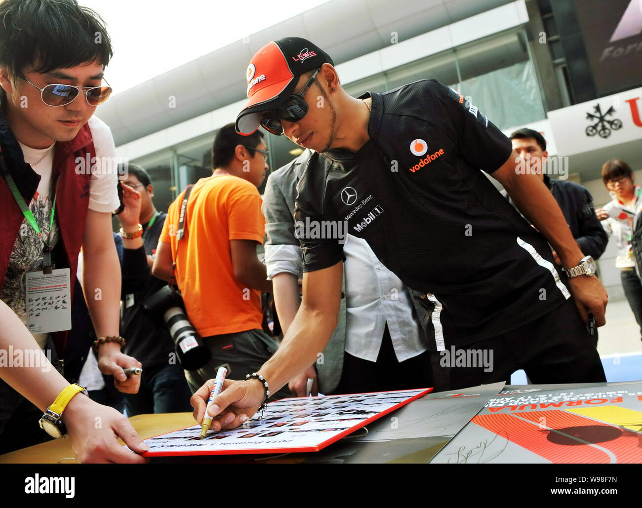 British F1 driver Lewis Hamilton of the McLaren-Mercedes team signs for ...
