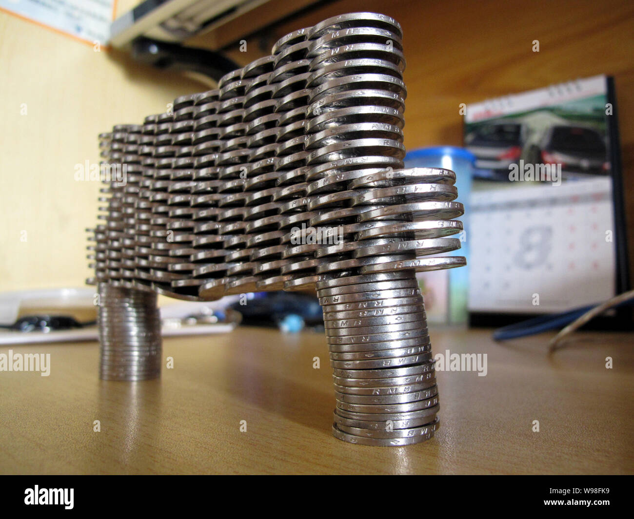 A shape made up of coins in the form of the London Bridge is pictured ...