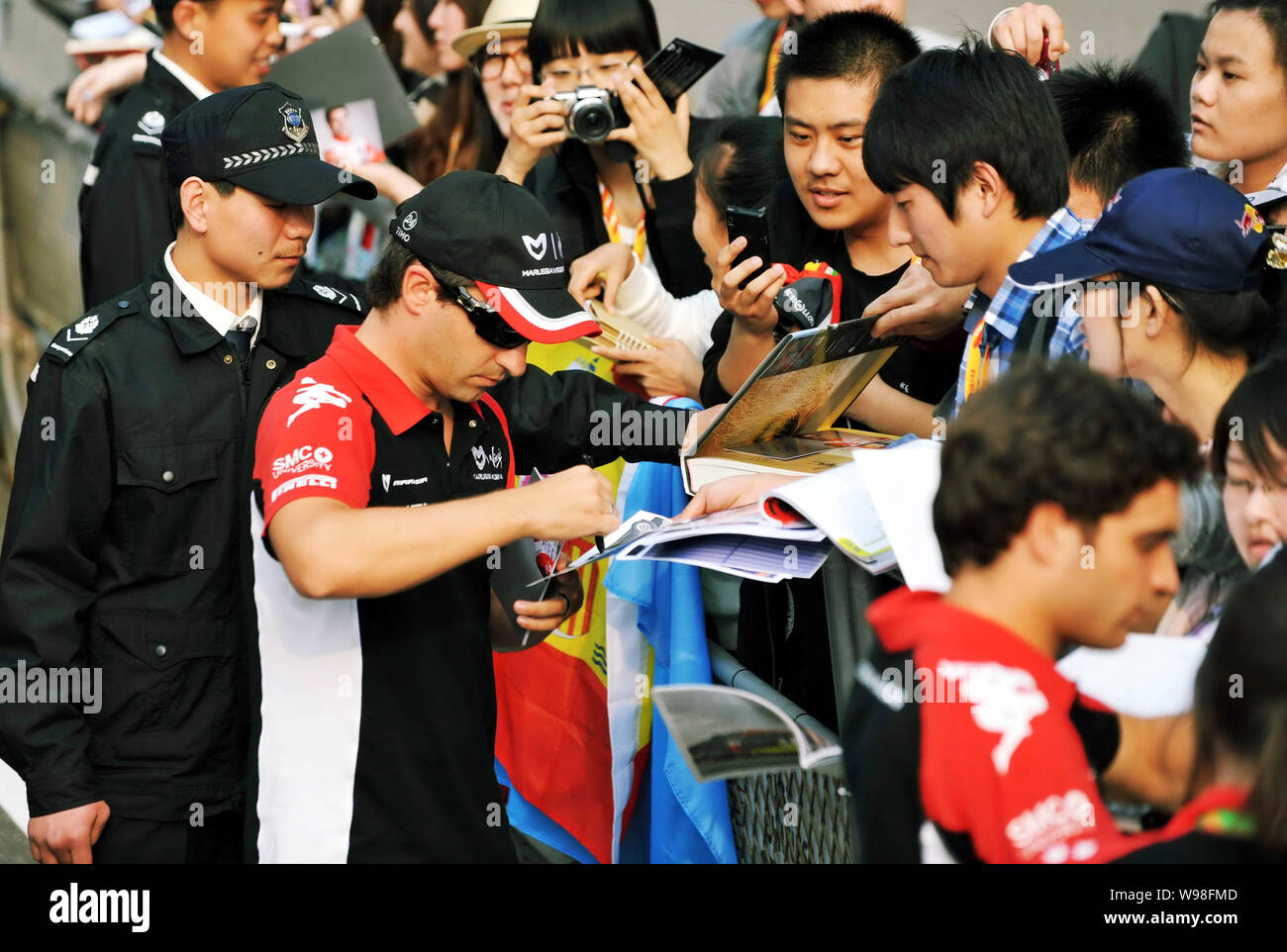 German F1 driver Timo Glock of the Virgin Racing team signs for fans at ...