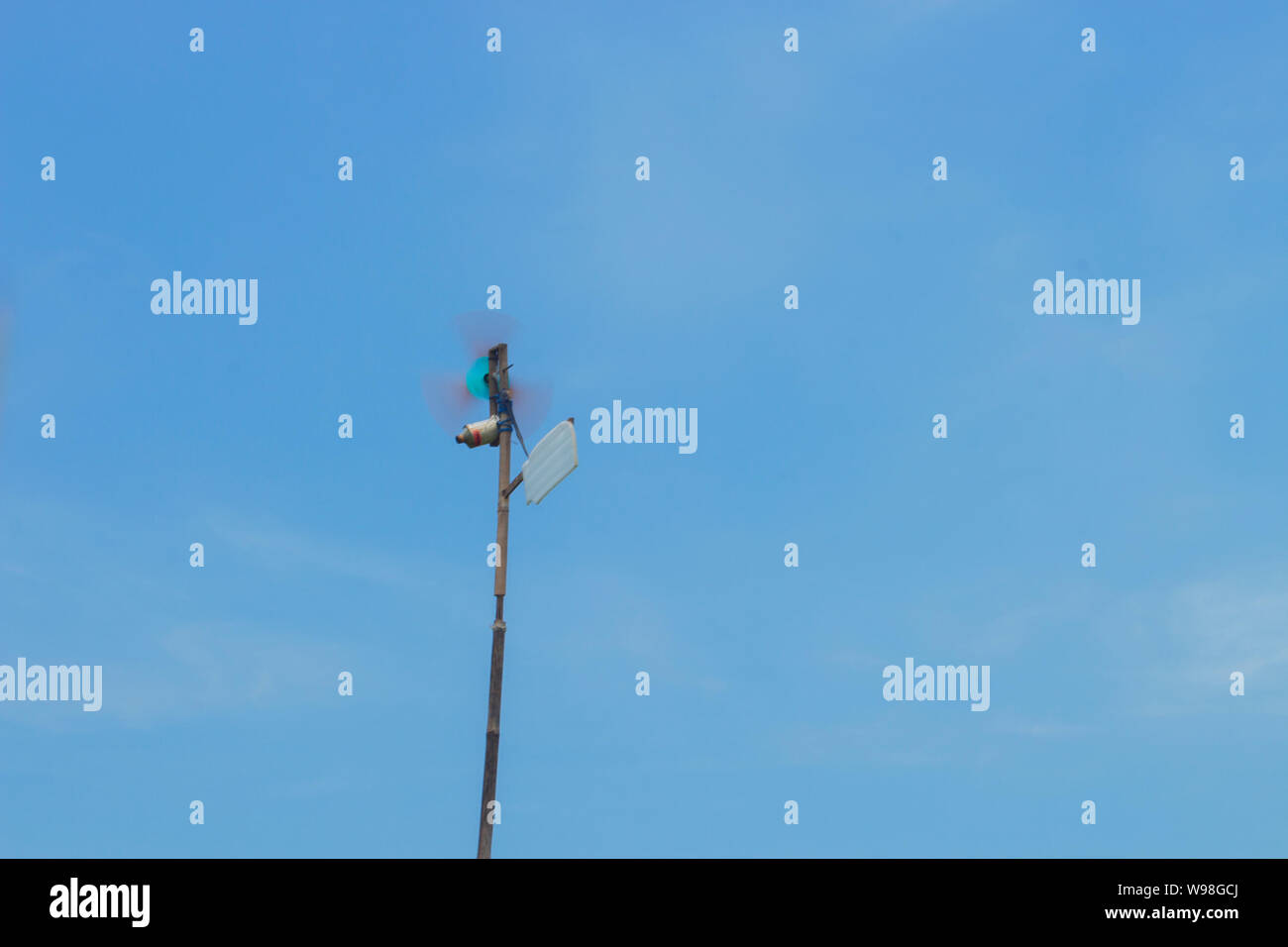 Traditional Windmill Made From Used Can Spinning on The Blue Sky in ...
