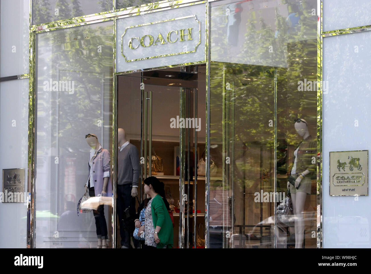 A Chinese woman leaves a Coach boutique at the Hong Kong Plaza in ...