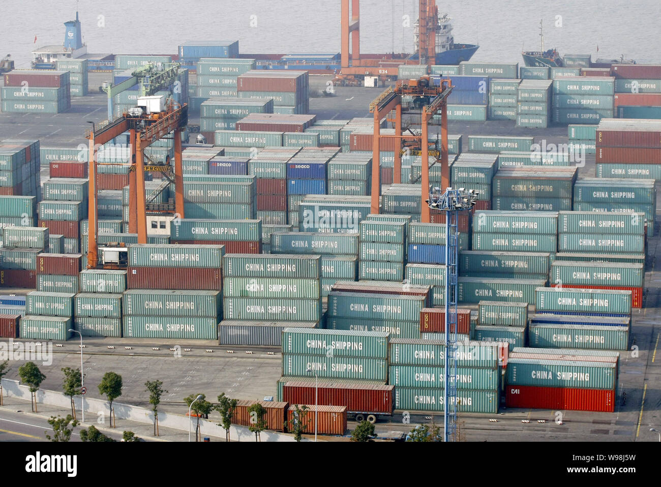 Containers and cranes are seen at a container terminal in Shanghai ...