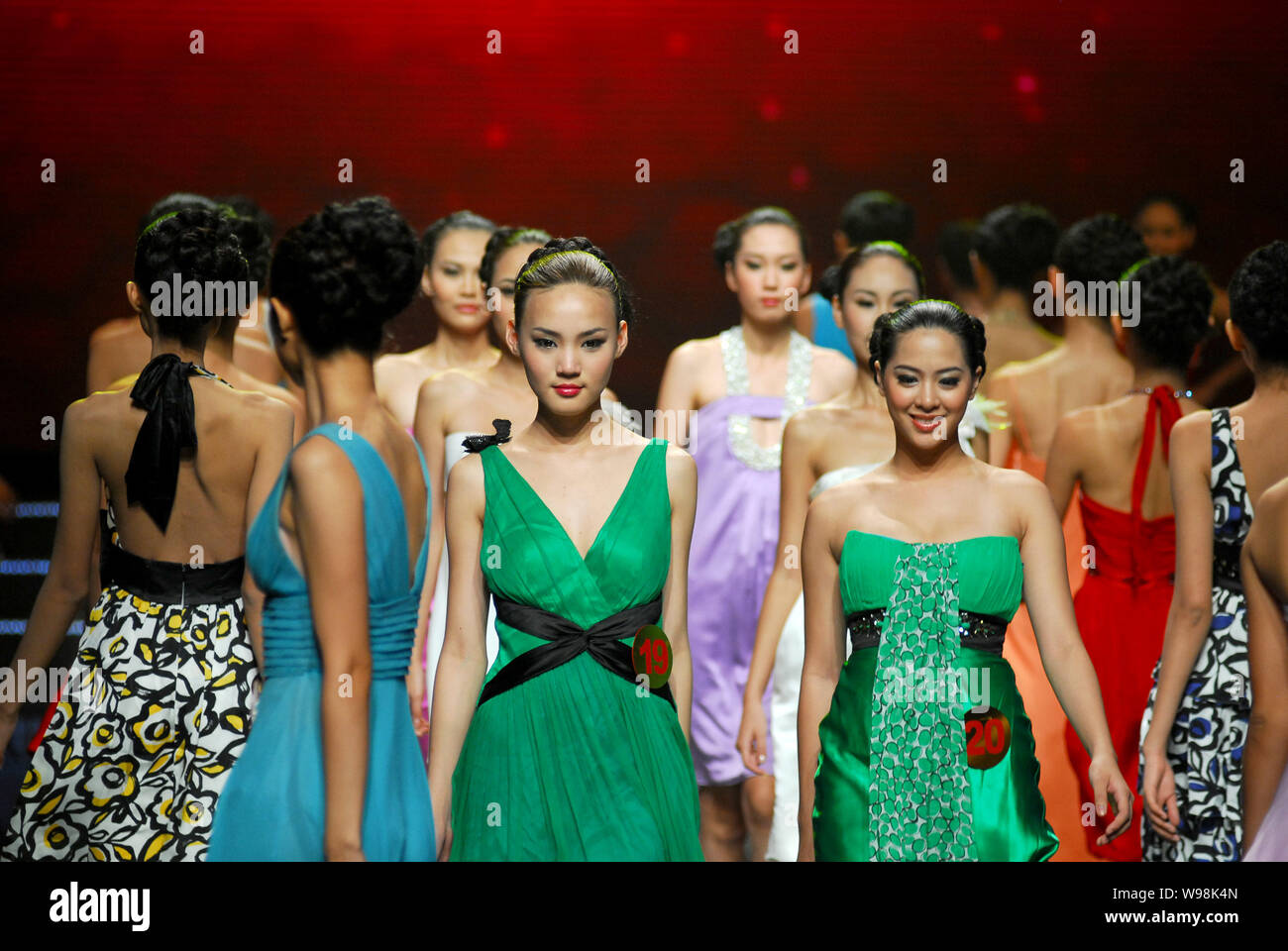Models wearing garments with Chinese elements pose on the stage during ...