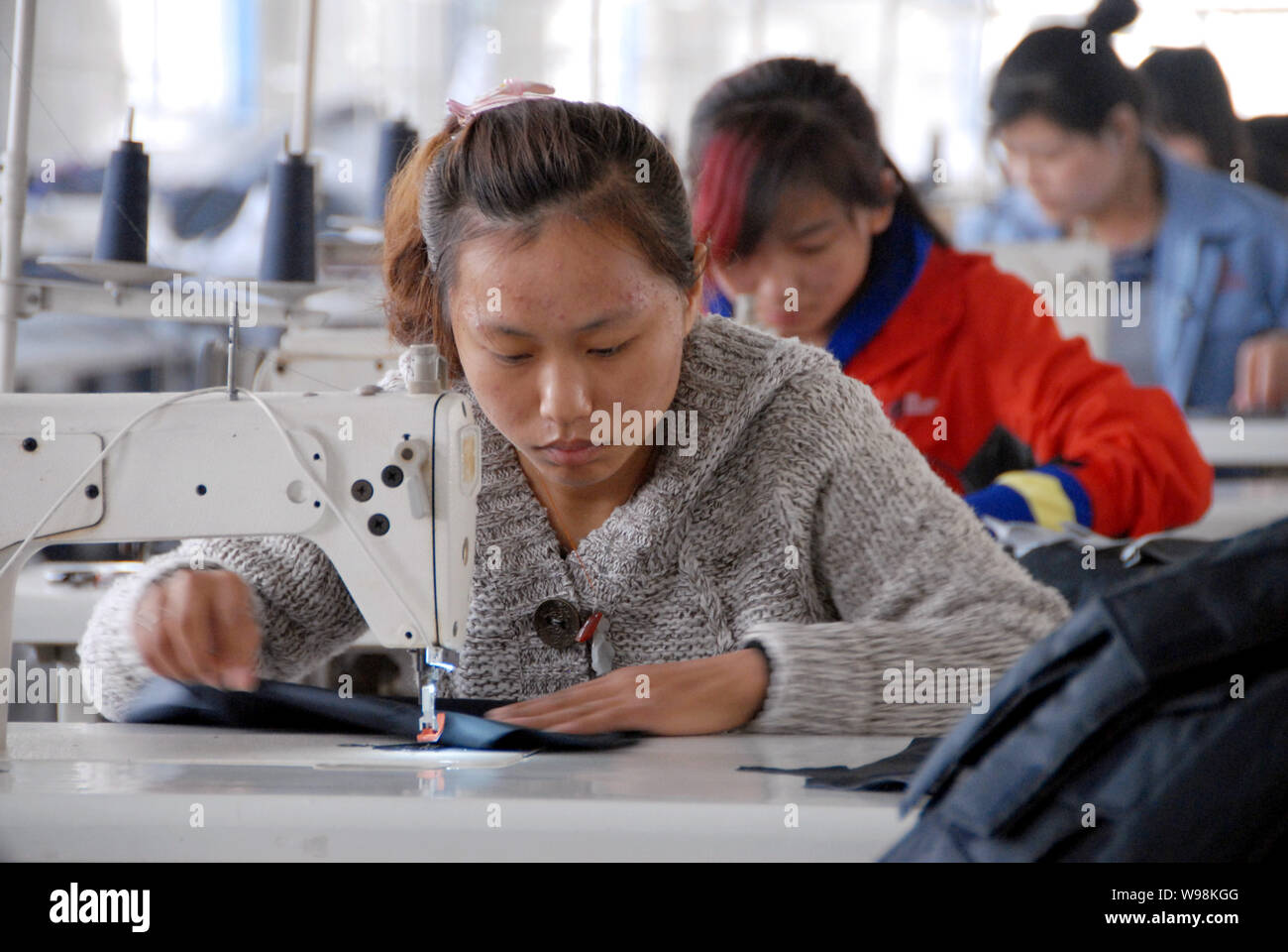 --FILE--Female Chinese workers make clothing at a garment factory in ...