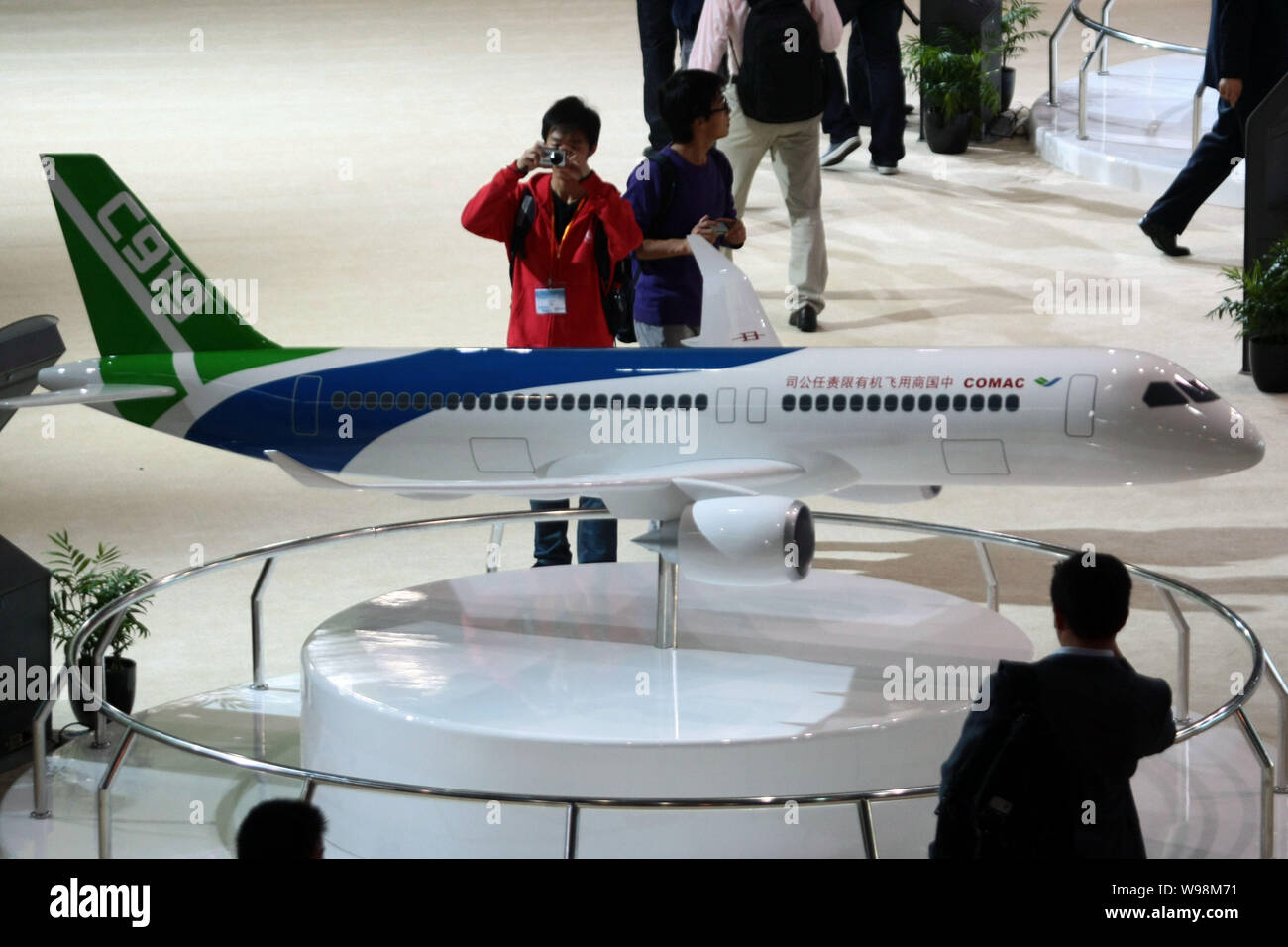 Visitors take photos of a model of Chinese developed C919 airplane of ...
