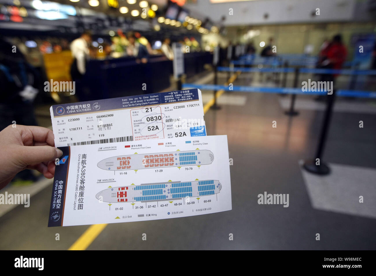 A passenger shows his ticket for the flight on Chinas first Airbus A380 ...
