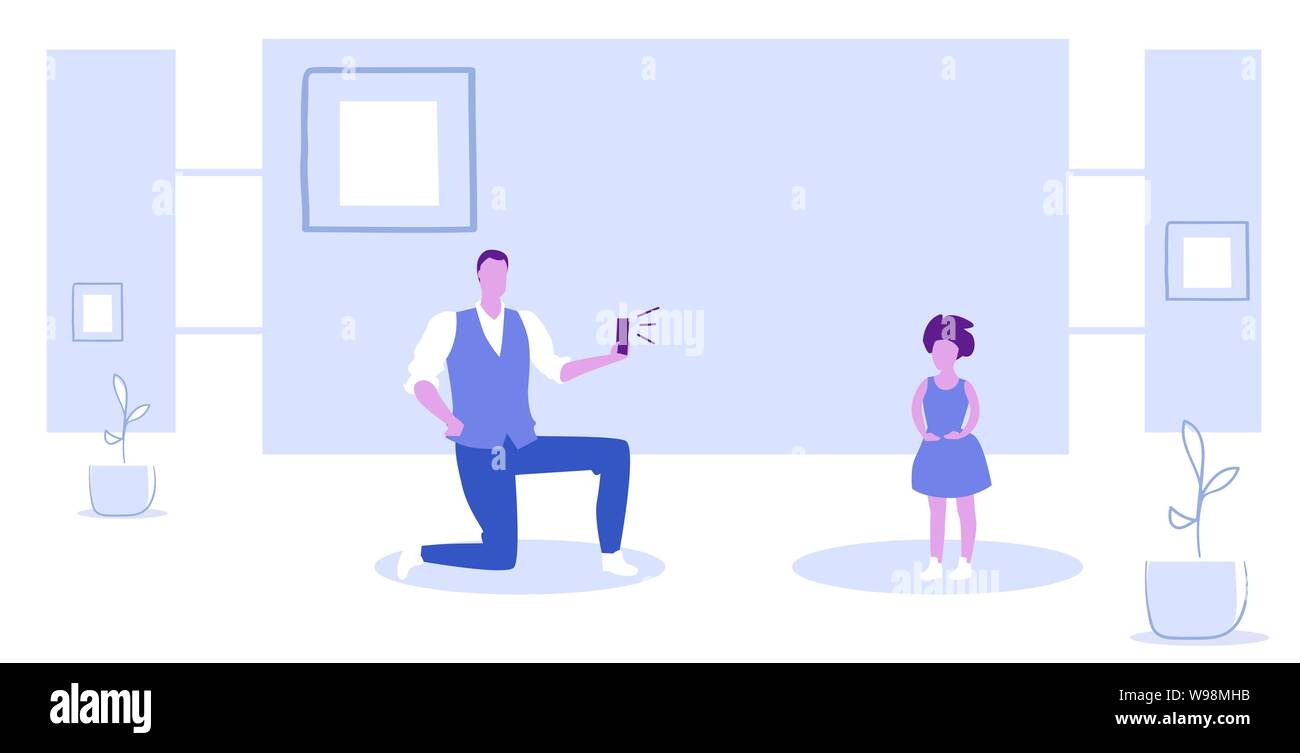 man using smartphone camera father standing on knee taking photo of ...