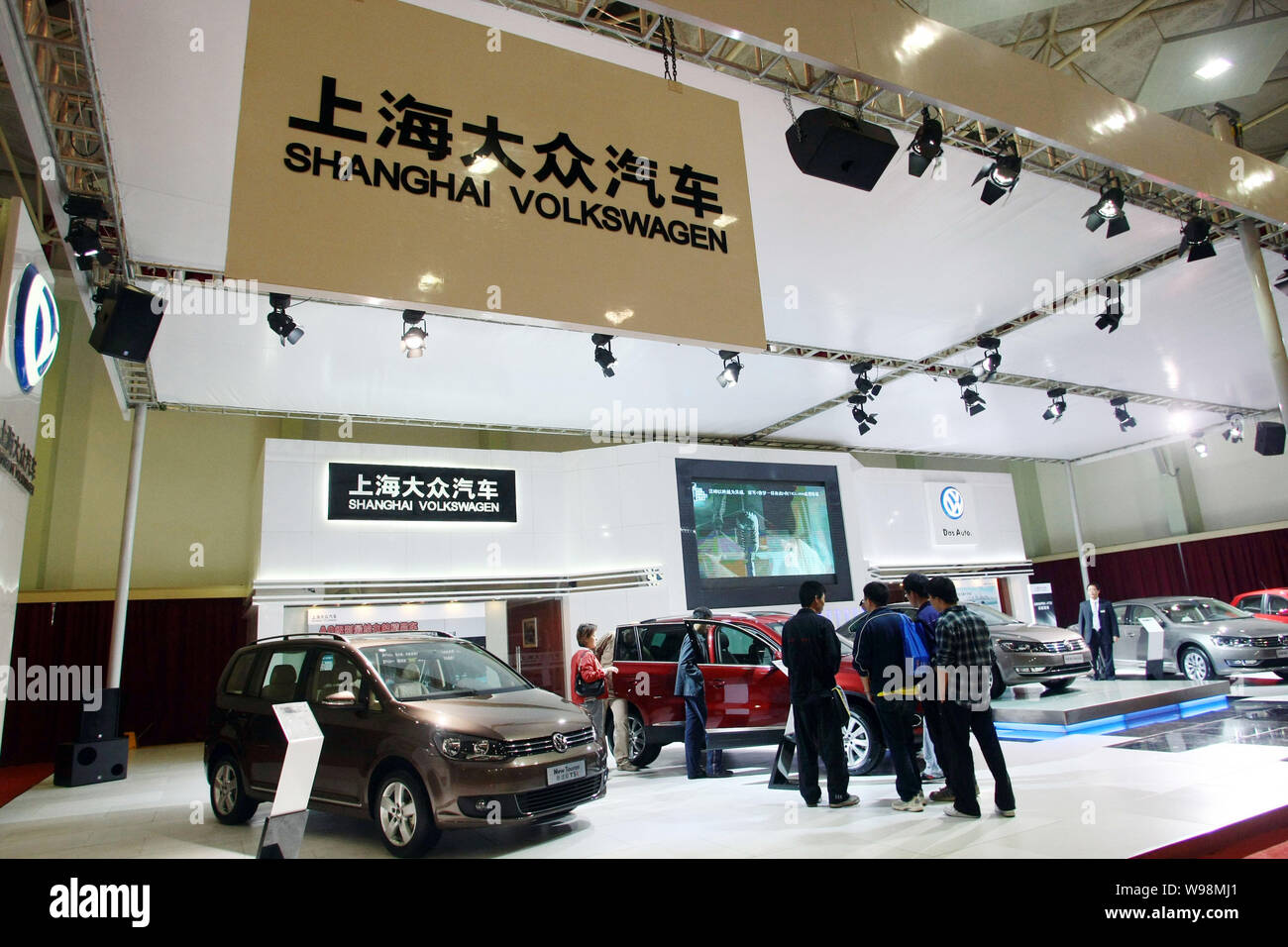 --FILE--Visitors look at Volkswagen cars at the stand of Shanghai ...