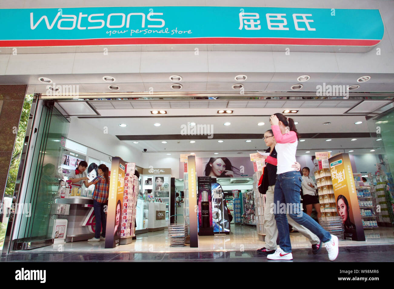--FILE--Pedestrians walk past a Watsons store in Shanghai, China, 22 ...