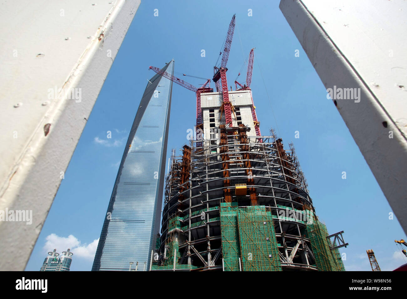 The Shanghai Tower, right, is under construction next to the Shanghai ...