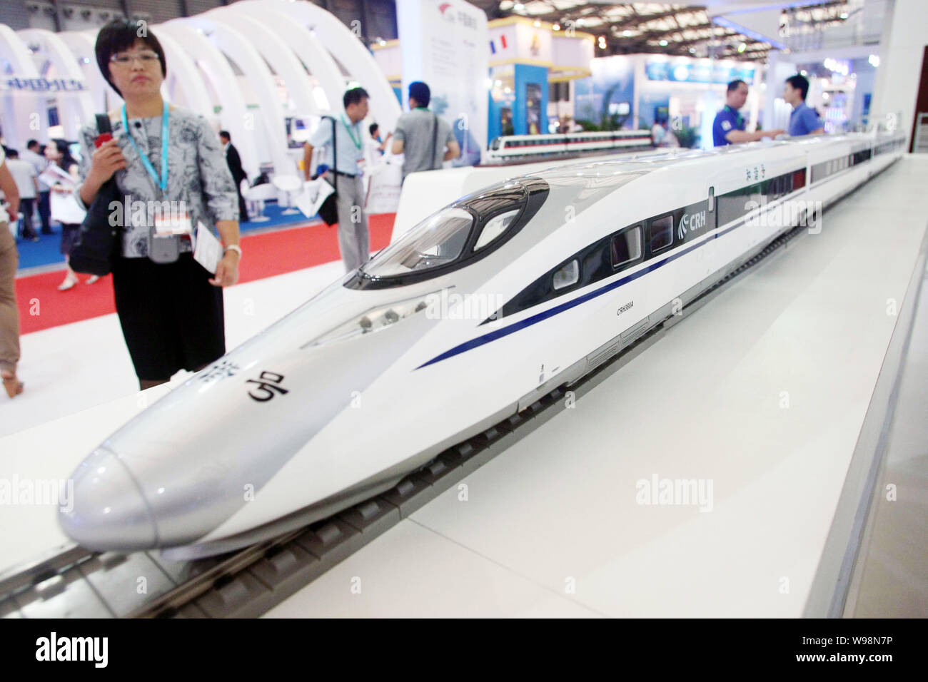 A visitor looks at a model of the CRH380A bullet train during the 7th ...