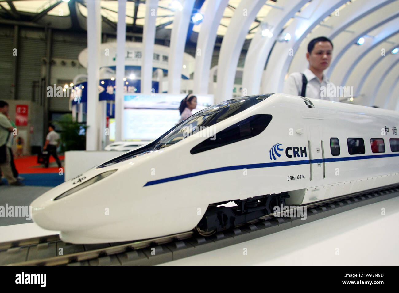 A visitor looks at a model of the CRH5 bullet train during the 7th China International Rail ...