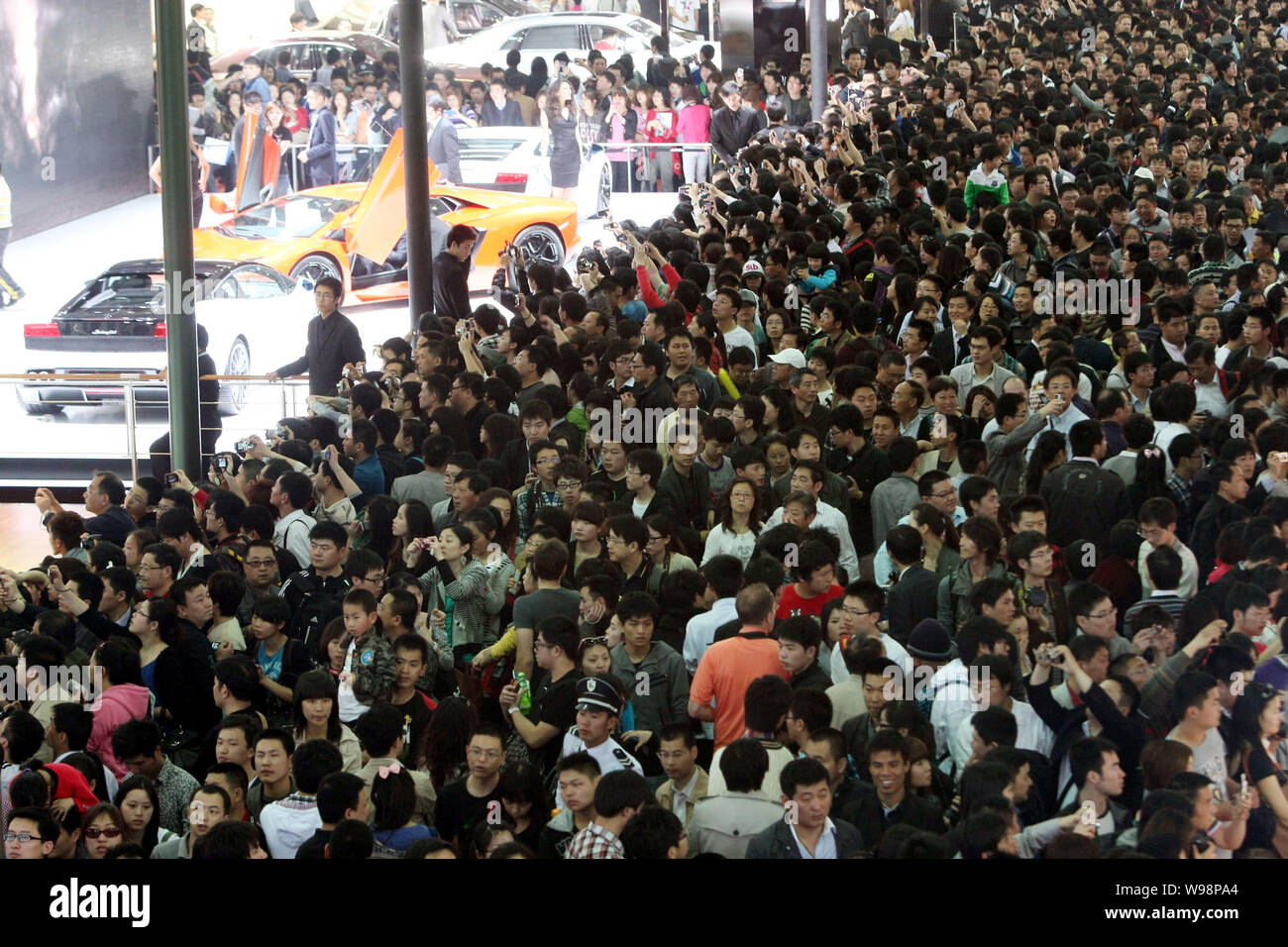 Visitors crowd booths at the 14th Shanghai International Automobile ...