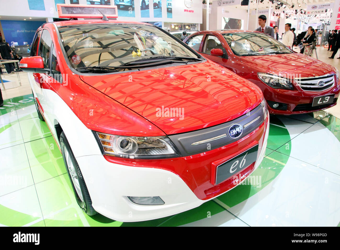 --FILE--Visitors look at the BYD e6 EV and the BYD L3 at the 14th ...