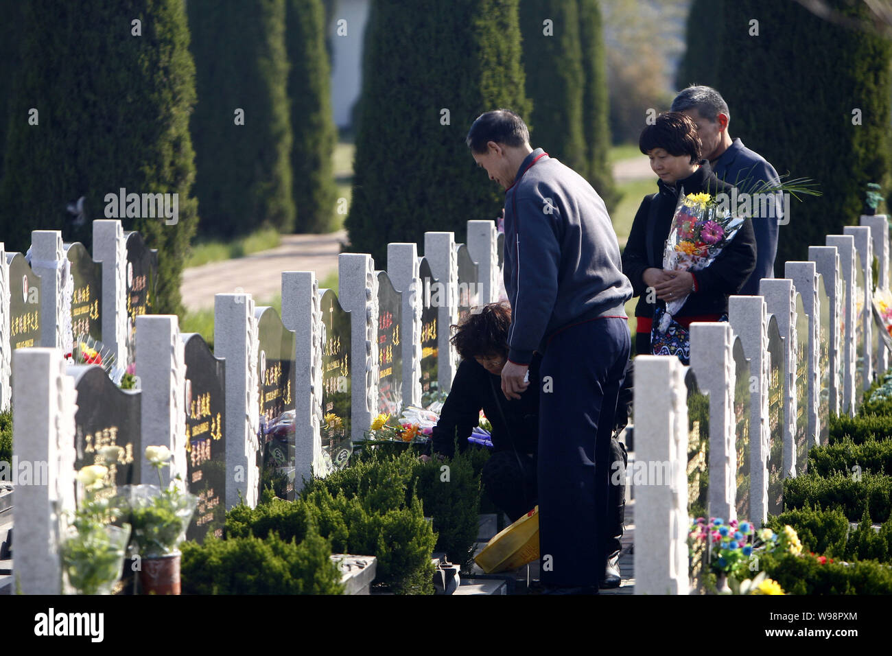 Local Chinese residents mourn their deceased family members at a ...