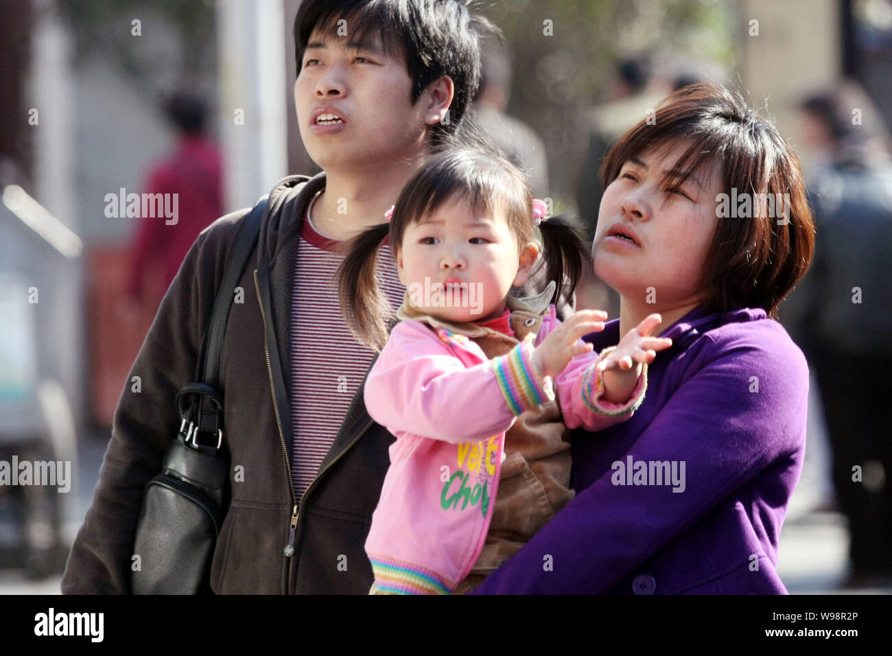 --FILE--A Chinese family of three is pictured on a shopping street in ...