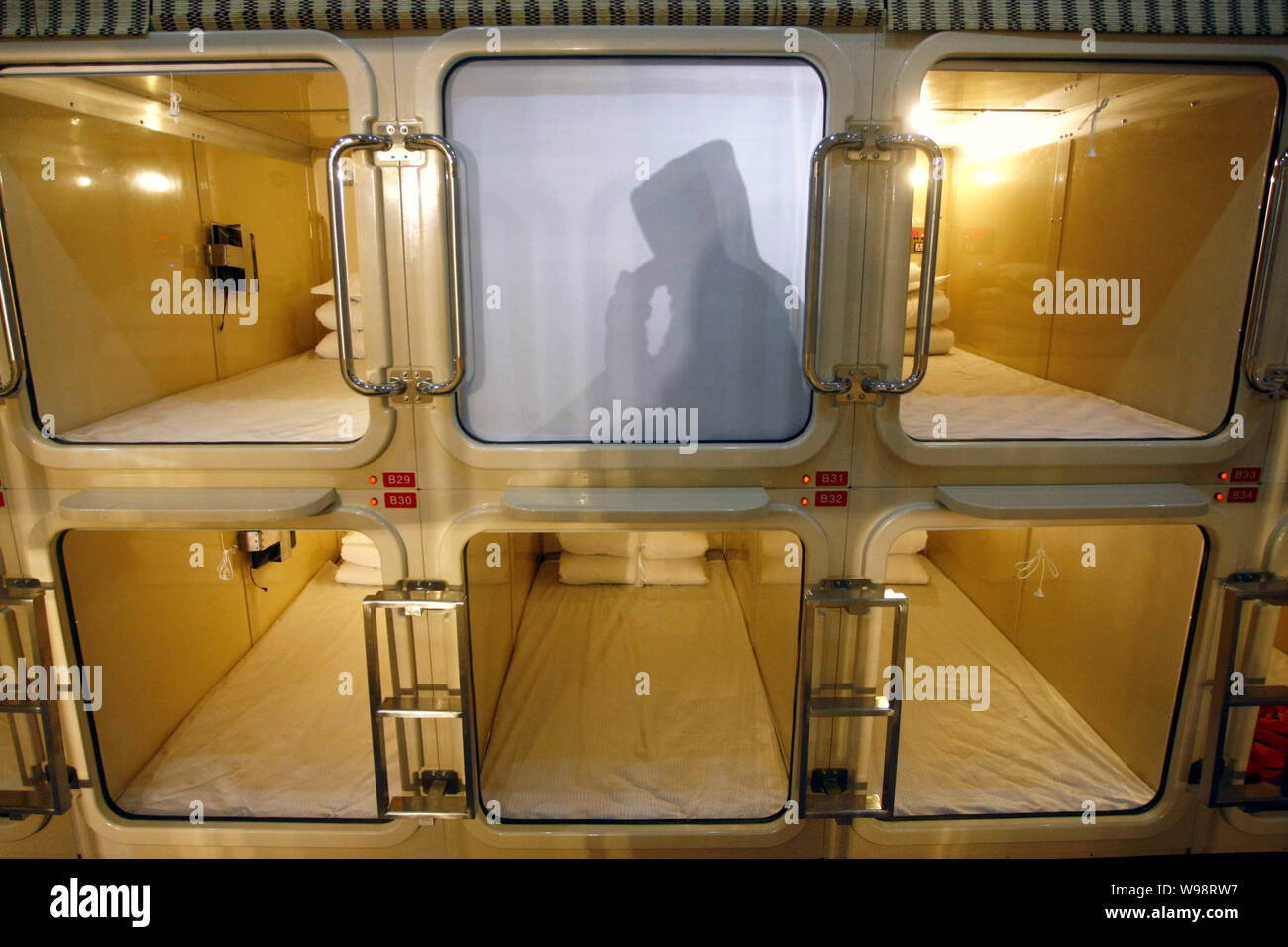 A Chinese man rests in a cabinet-sized room at Chinas first capsule ...