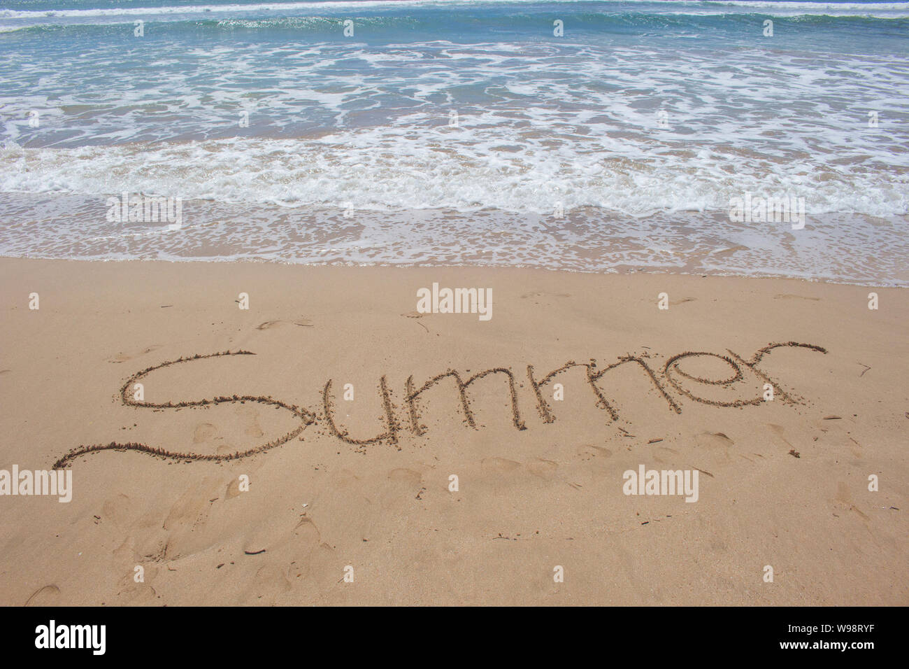Writing Summer With Blue Sea Water on The Beach Stock Photo - Alamy
