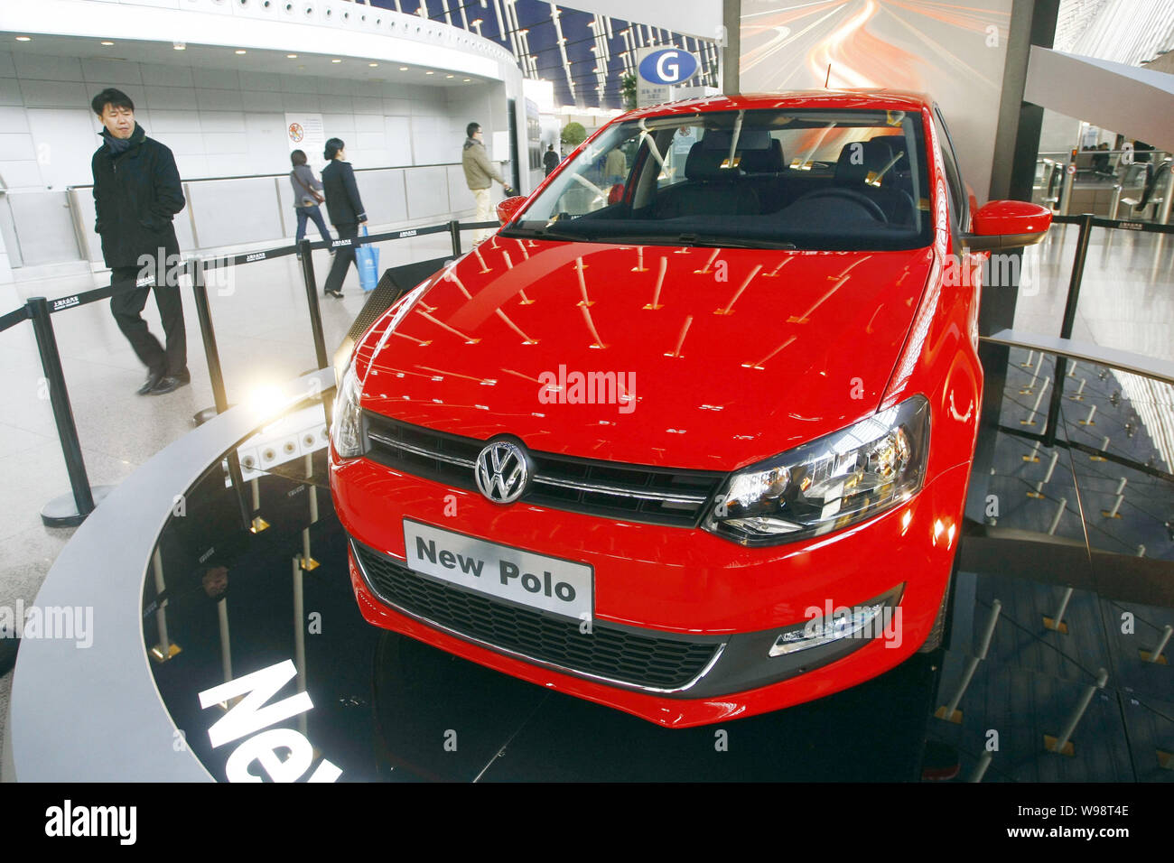 --FILE--Passengers look at the New Polo of Shanghai Volkswagen, a joint ...