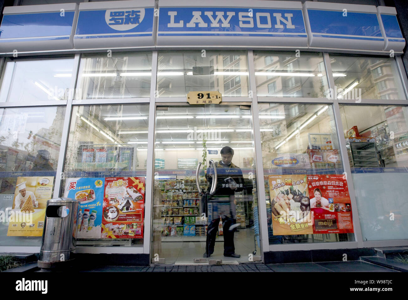 --File--A Chinese customer walks out of a Lawson convenience store in ...