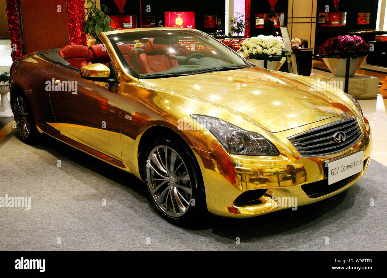 A gold Infiniti G37 Coupe Convertible is exhibited at a gold and jewel ...