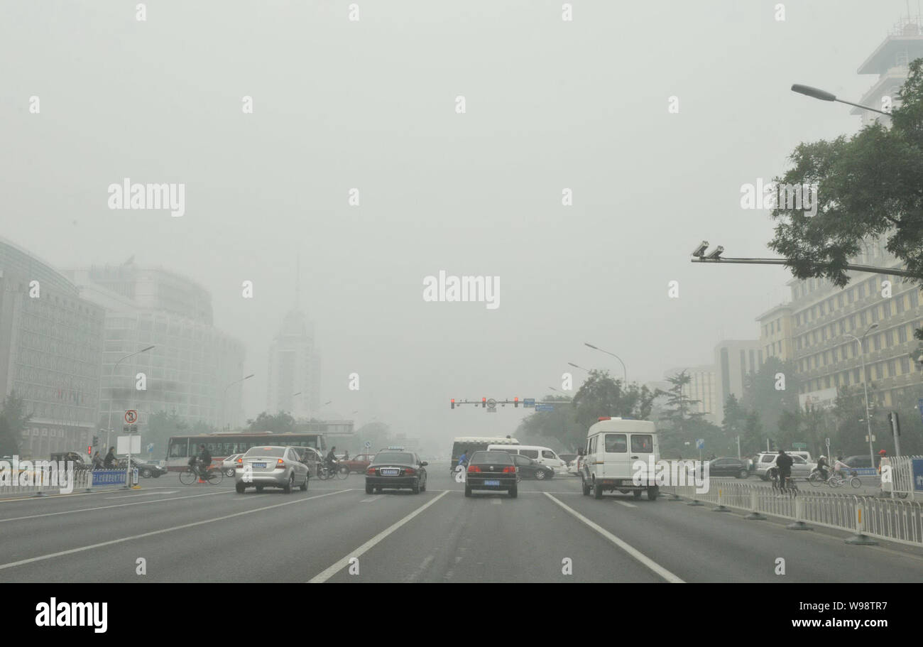 Cars travel in fog on a road in Beijing, China, 9 October 2011. Dense ...