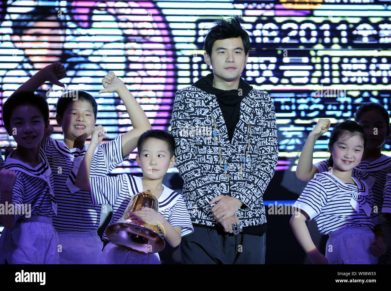 Taiwanese singer and actor Jay Chou poses with young kids at a press ...
